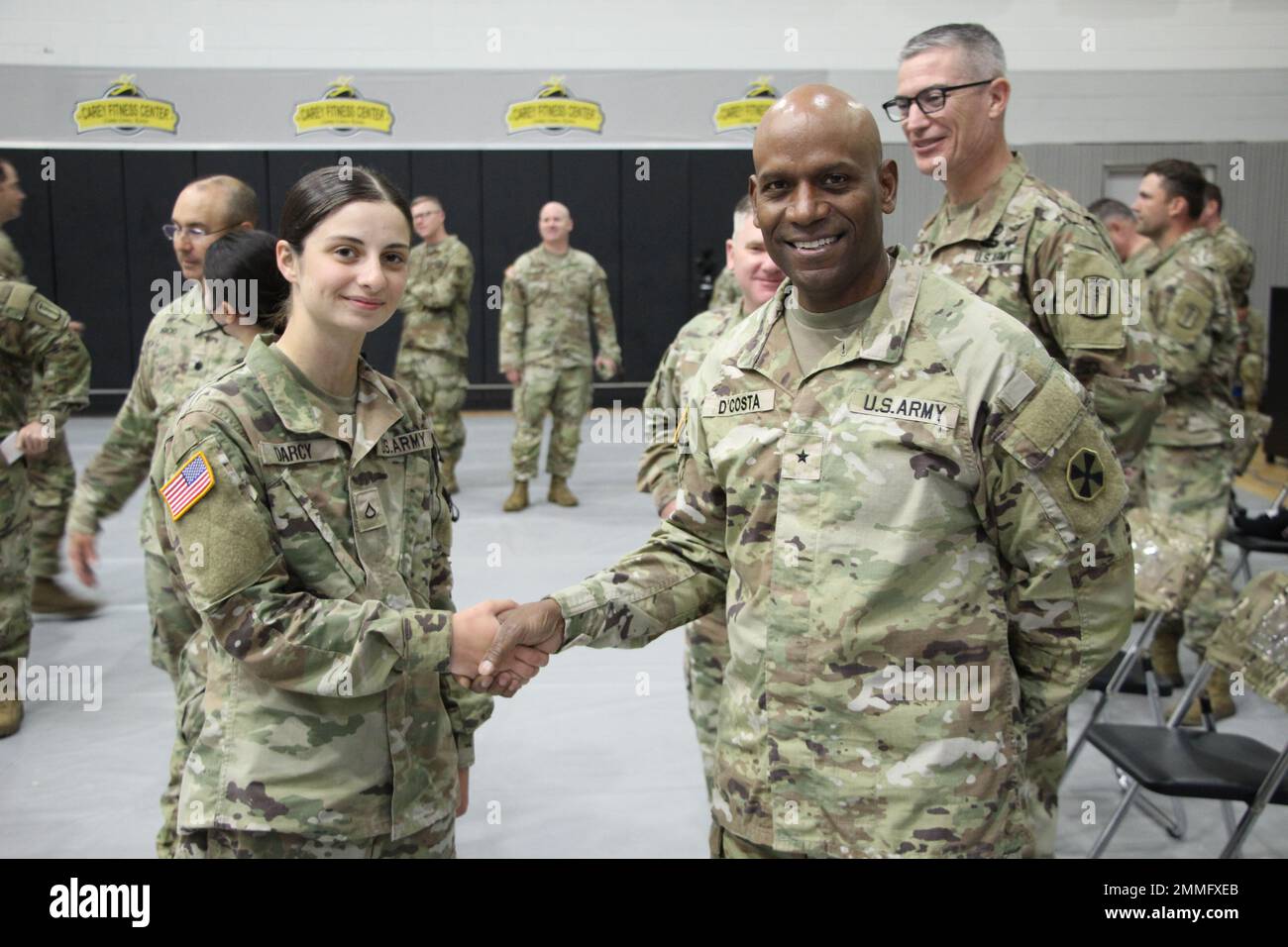 Brig. Gen. Joseph D'Costa recognized Pfc. Angelina Darcy with a coin of ...