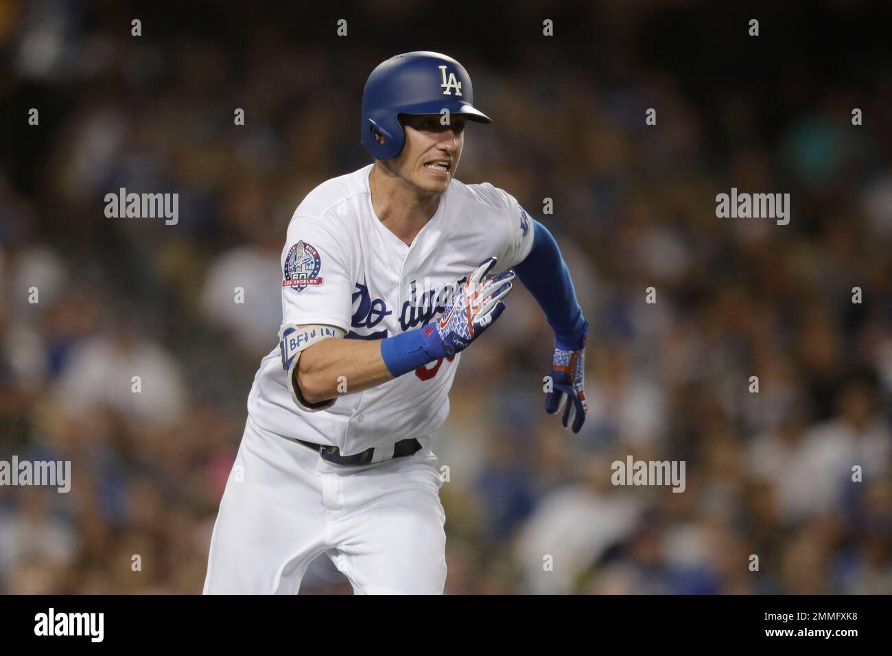Los Angeles Dodgers' Cody Bellinger runs to first base after hitting a ...