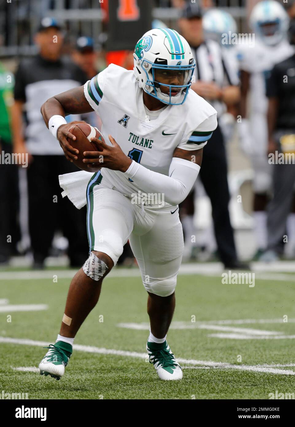 Tulane quarterback Jonathan Banks looks for an opening to run through ...