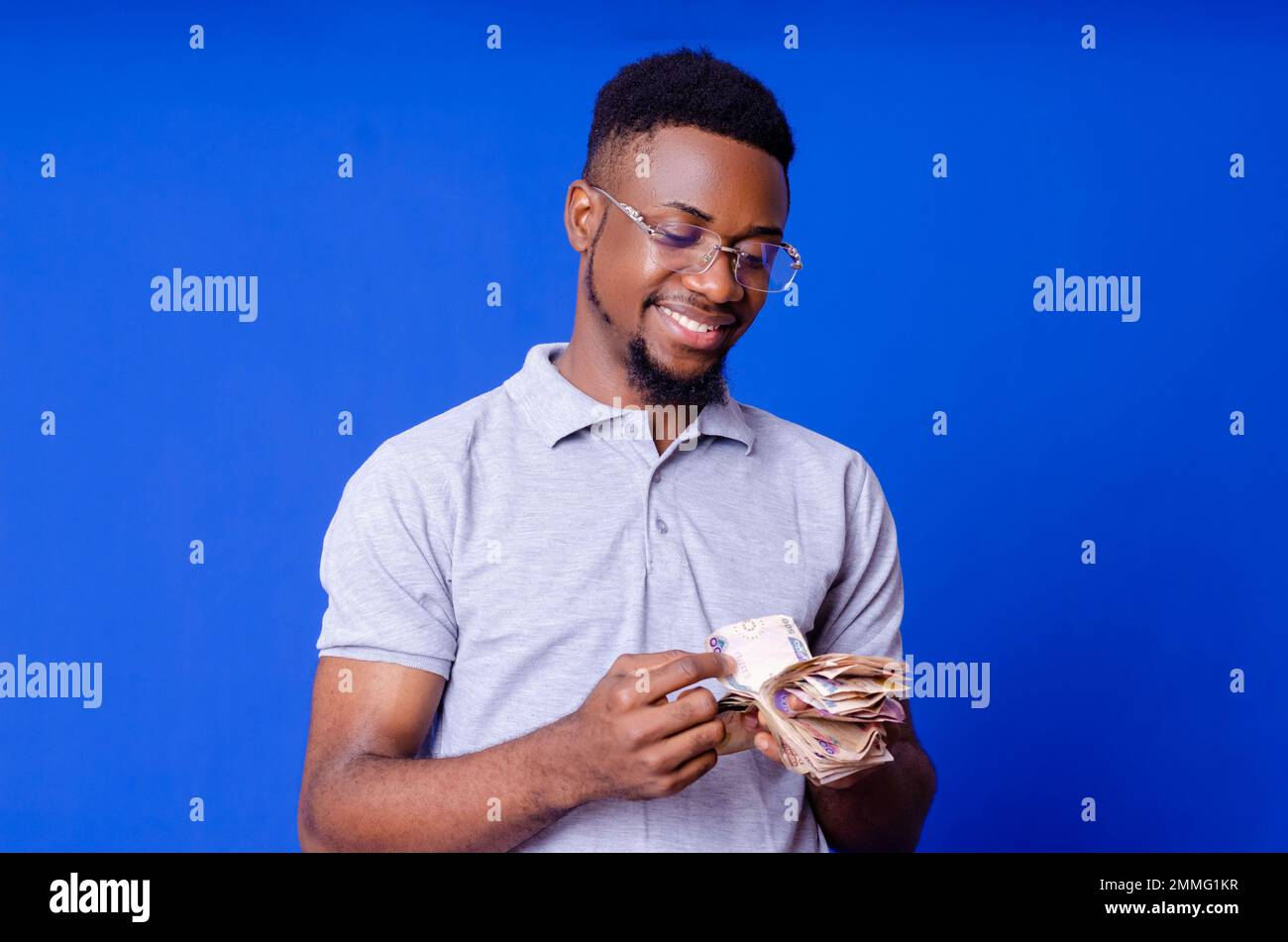 Successful business man counting money and smiling Stock Photo - Alamy