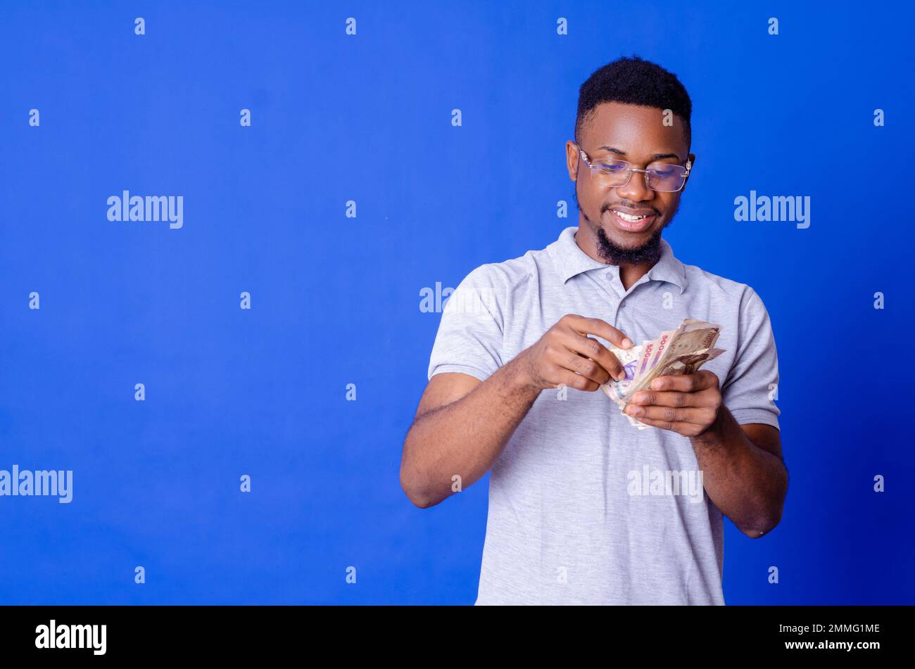 Successful business man counting money and smiling Stock Photo - Alamy