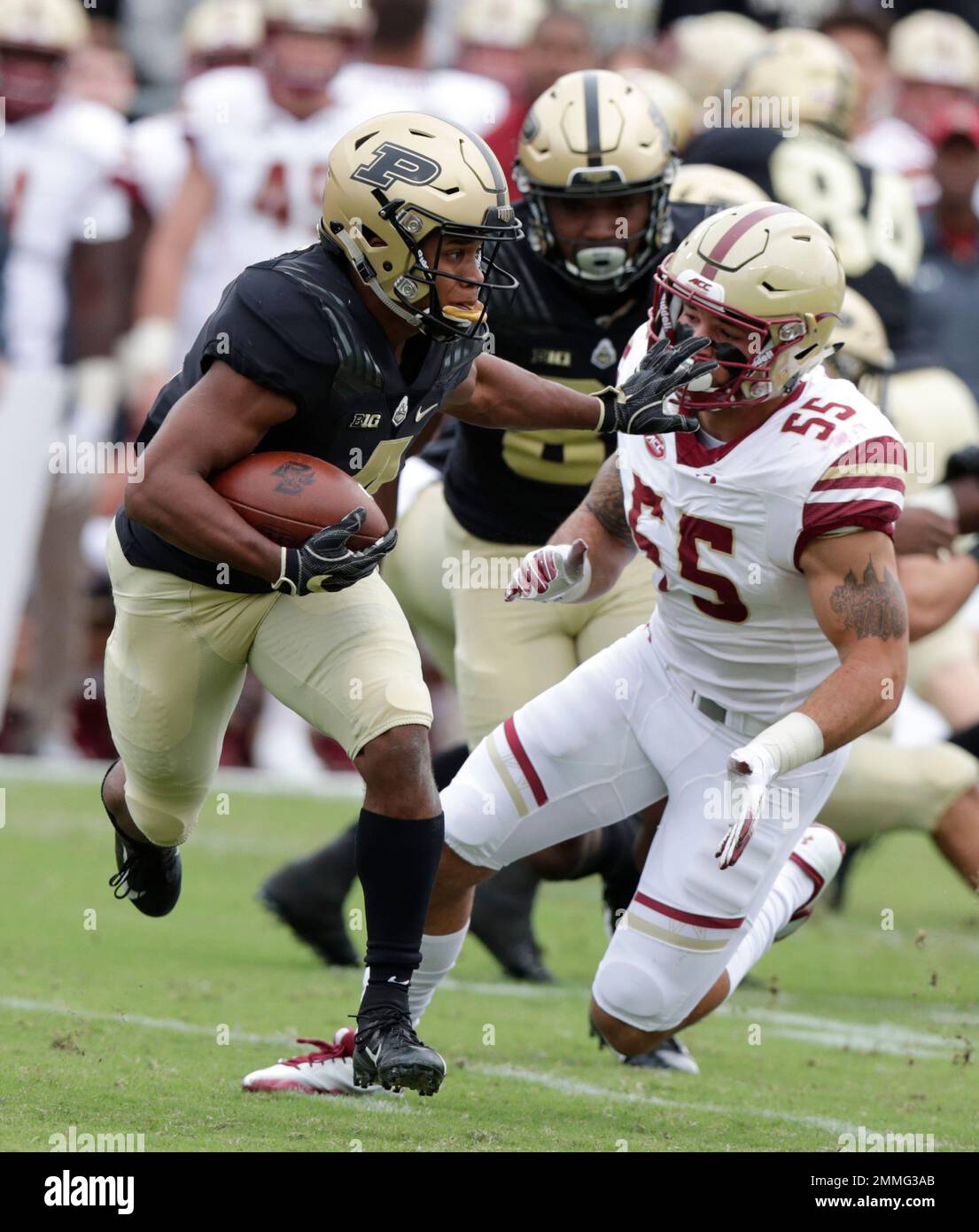 Purdue wide receiver Rondale Moore (4) pushes off Boston College ...