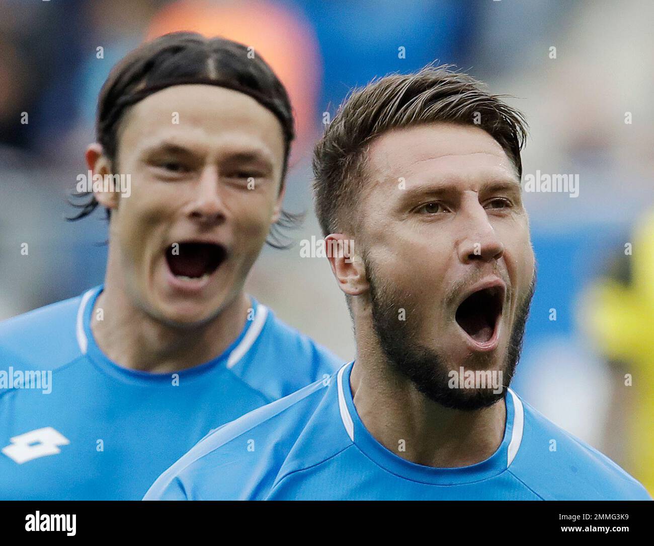 Hoffenheim's Ermin Bicakcic, right, celebrates after scoring an offside ...