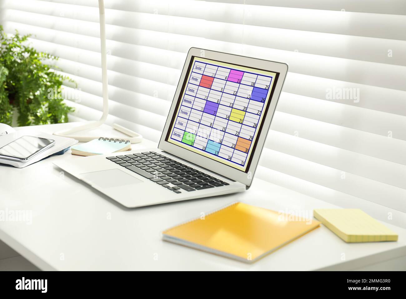 Modern laptop with calendar app at table in office Stock Photo - Alamy