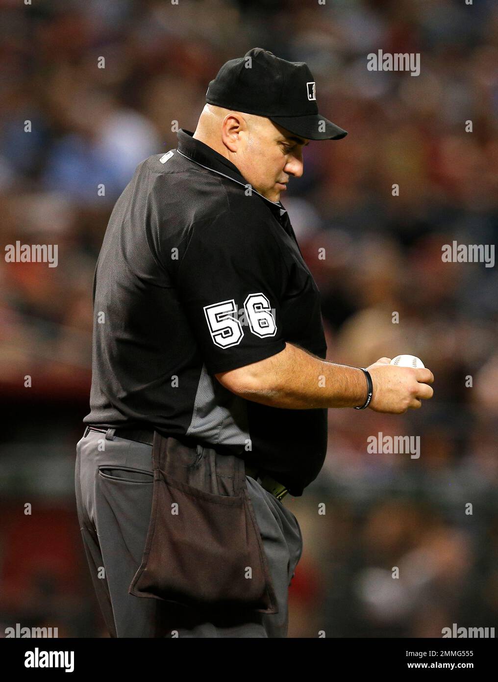 MLB umpire Eric Cooper (56) inspects the ball in the sixth inning ...