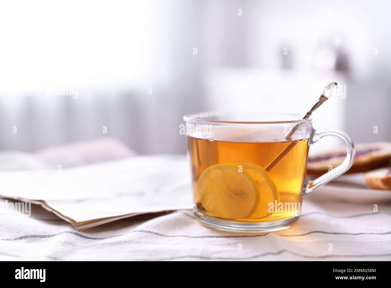 Morning tea and newspaper on fabric indoors. Space for text Stock Photo ...