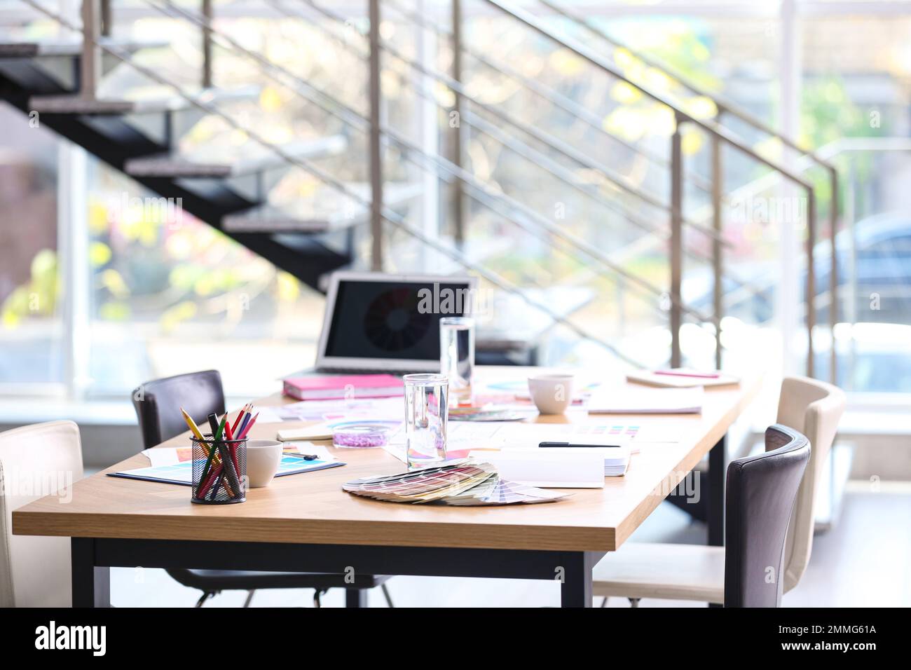 Meeting table with laptop and color palettes in interior designer's ...