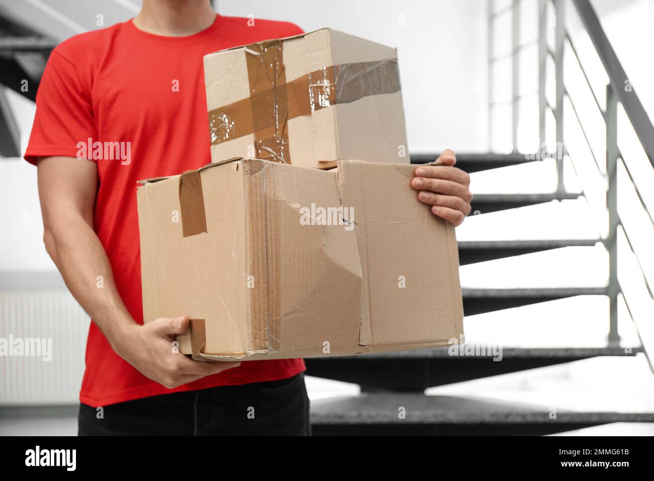 Courier with damaged cardboard boxes indoors, closeup. Poor quality ...