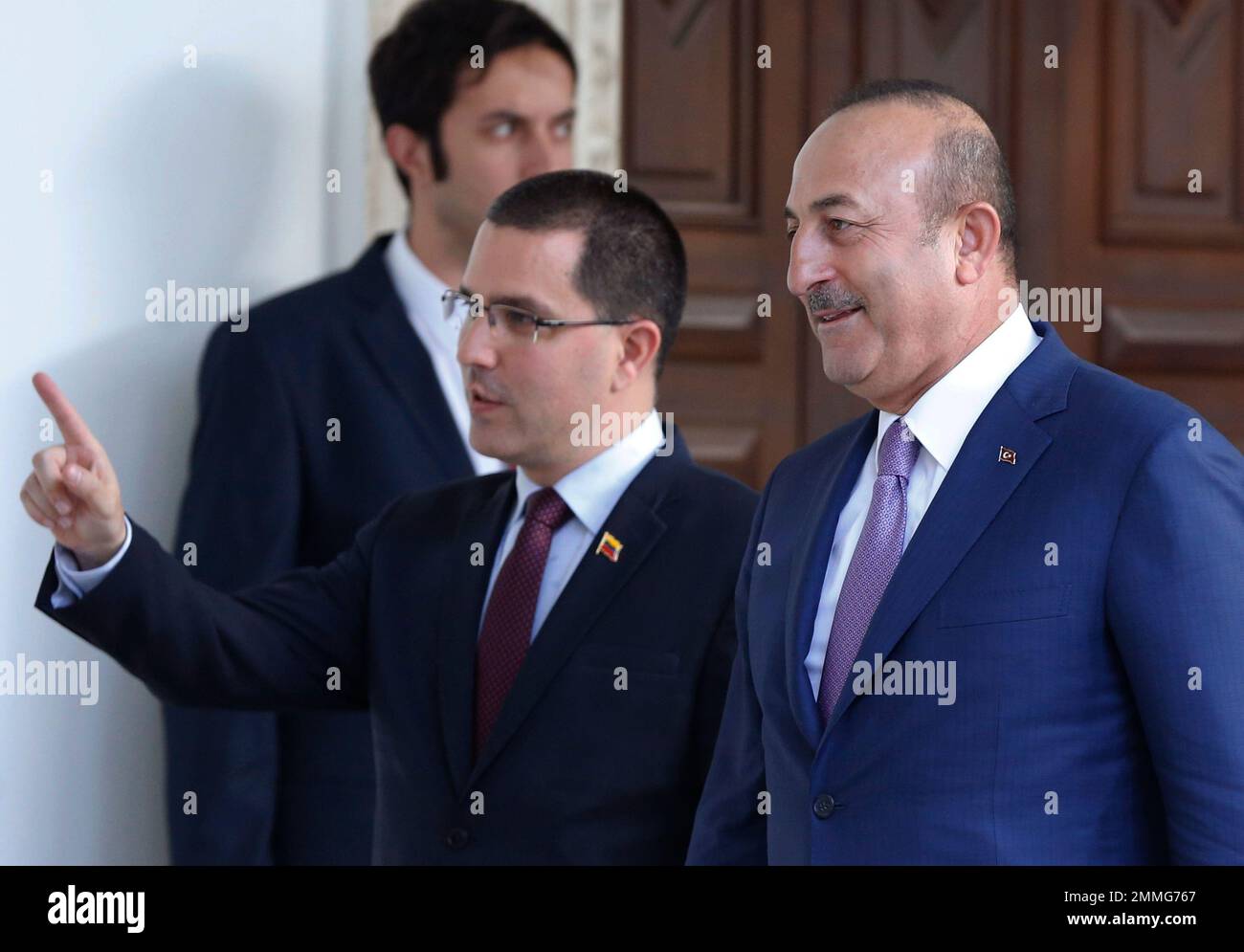 Turkey's Foreign Minister Mevlut Cavusoglu, right, walks with Venezuela ...