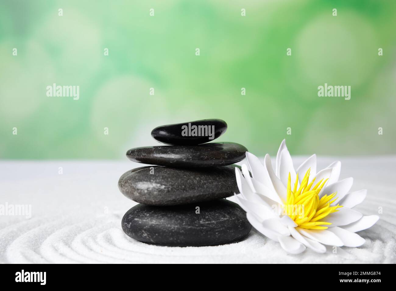 Zen garden. Beautiful lotus flower and stones on white sand Stock Photo ...