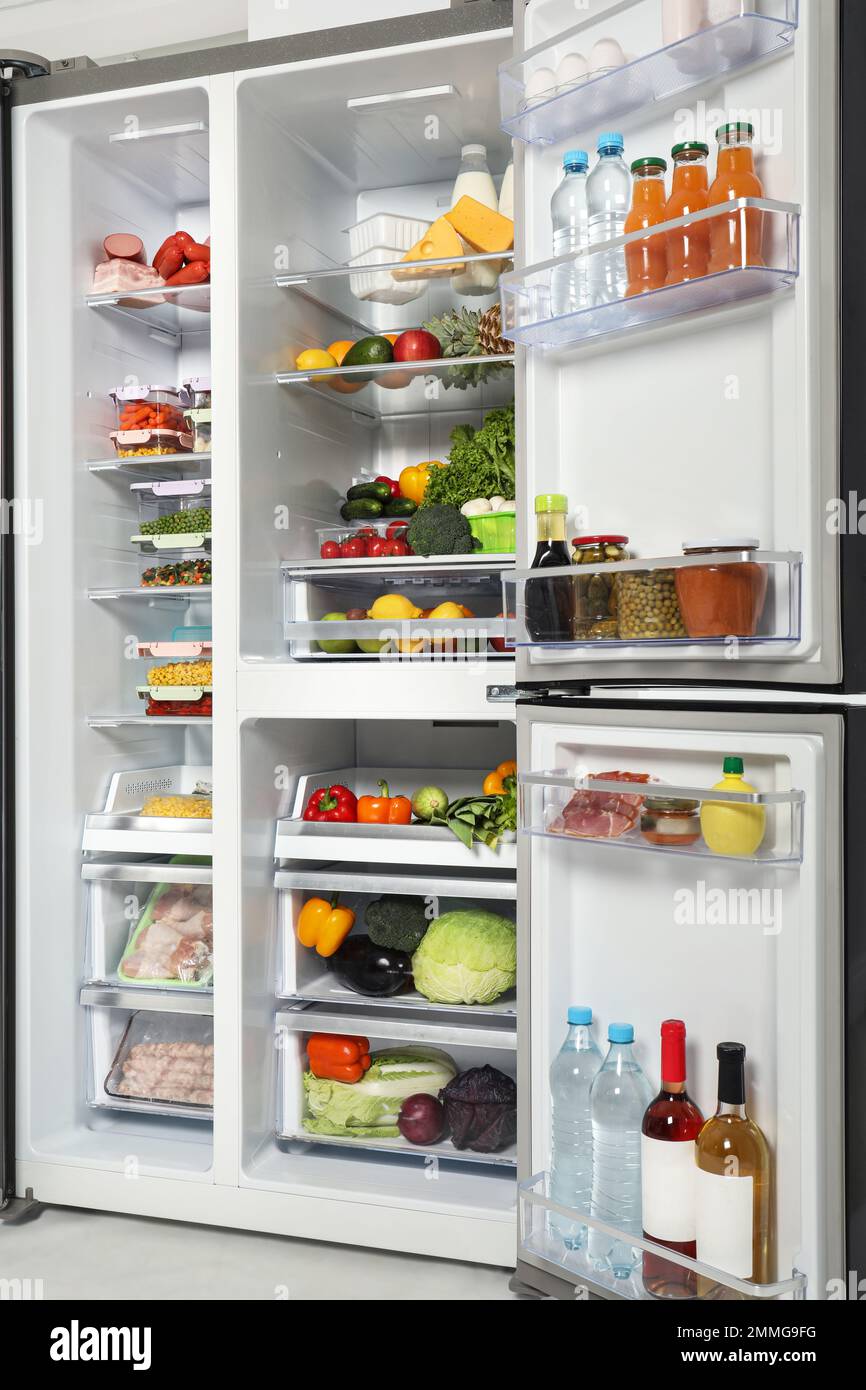 Open refrigerator full of different fresh products Stock Photo - Alamy