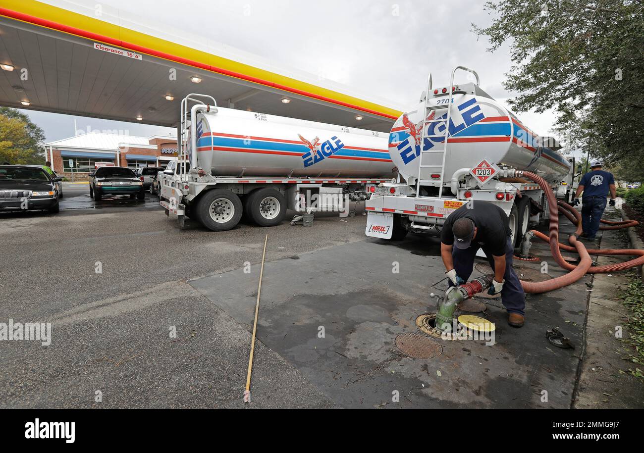 FILE- In this Sept. 17, 2018, file photo people wait in line as Travis ...
