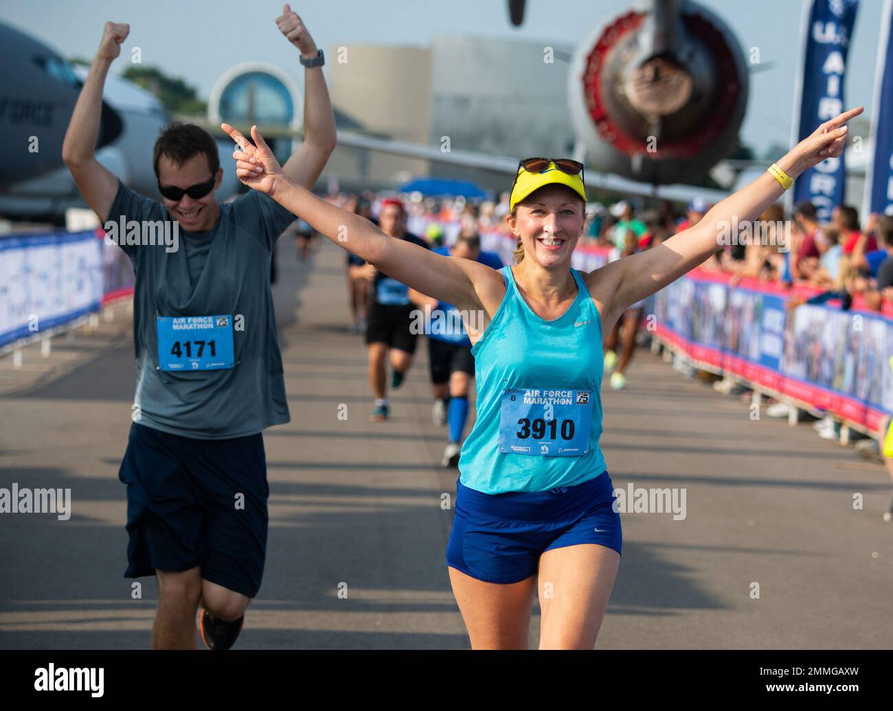 Maria Ruden and Joshua Latimer react as they cross the finish line of the half-marathon Sept. 17 ...