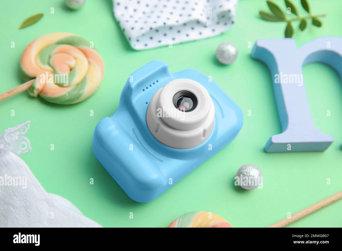 Light blue toy camera on light green background. Future photographer ...