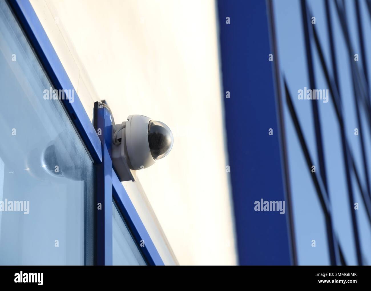 Modern CCTV camera on building wall outdoors Stock Photo - Alamy