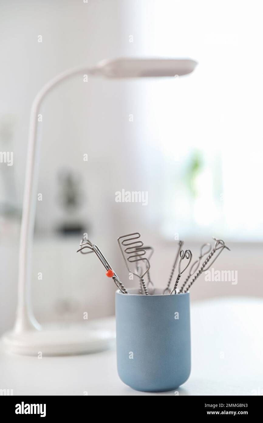 Set of different logopedic probes in holder on light table. Speech ...