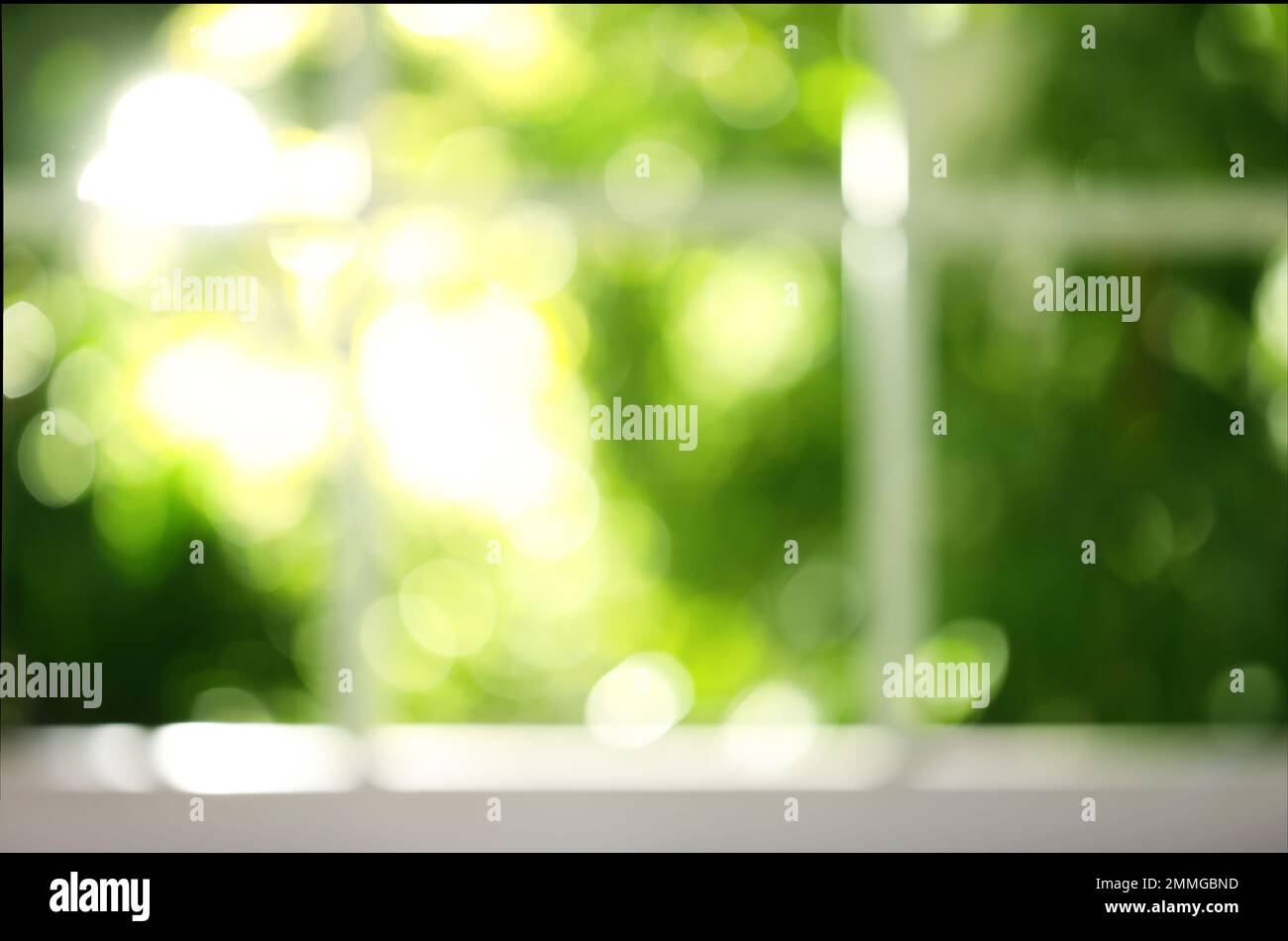 Blurred view through window on garden in morning Stock Photo - Alamy