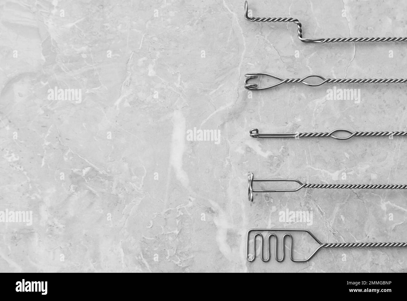 Set of different logopedic probes and space for text on marble table ...