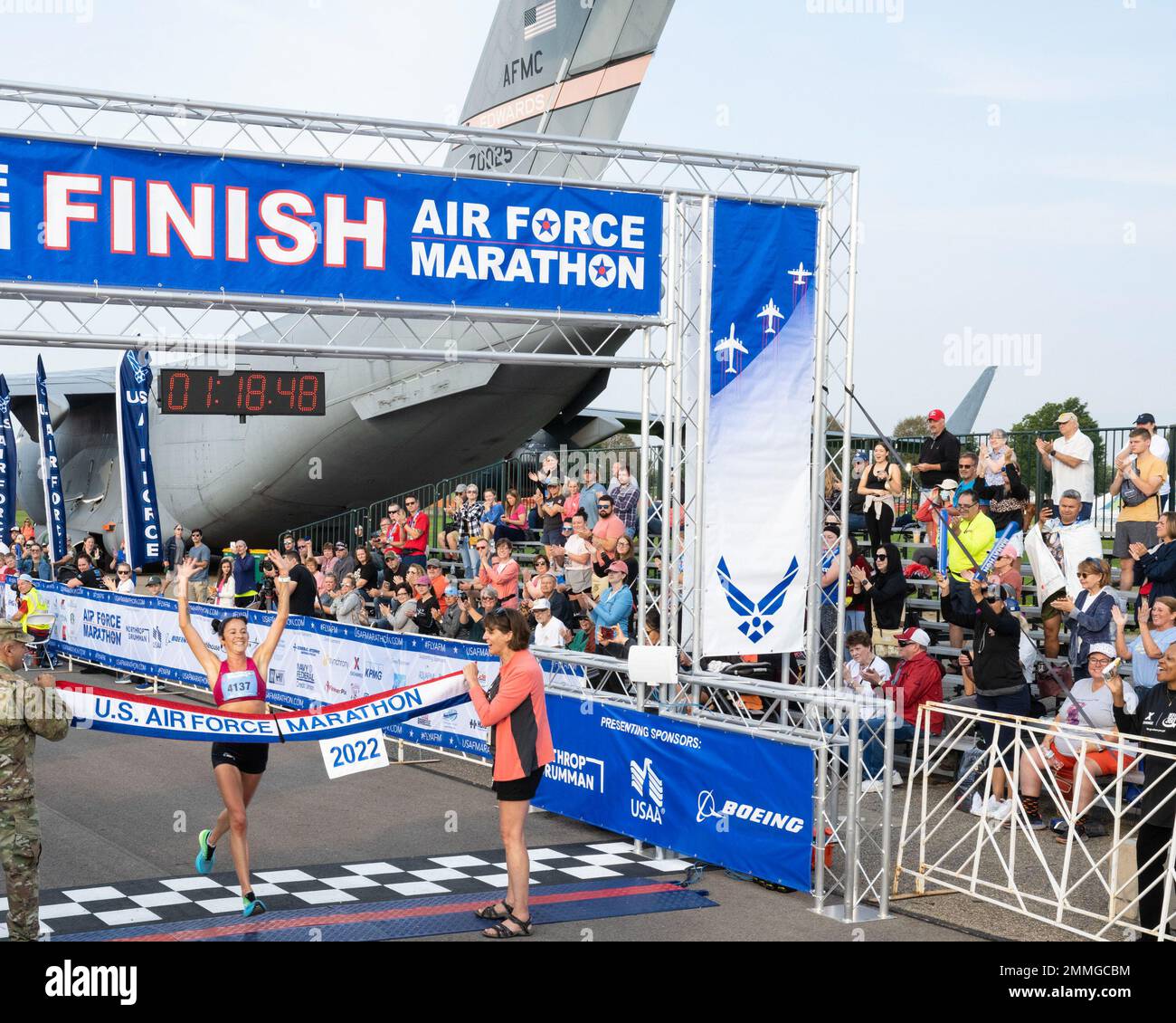Rebecca Murray crosses the finish line of the 10K race during the 2022 ...