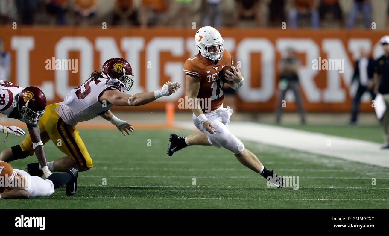 Texas quarterback Sam Ehlinger (11) is pressured buy USC linebacker ...