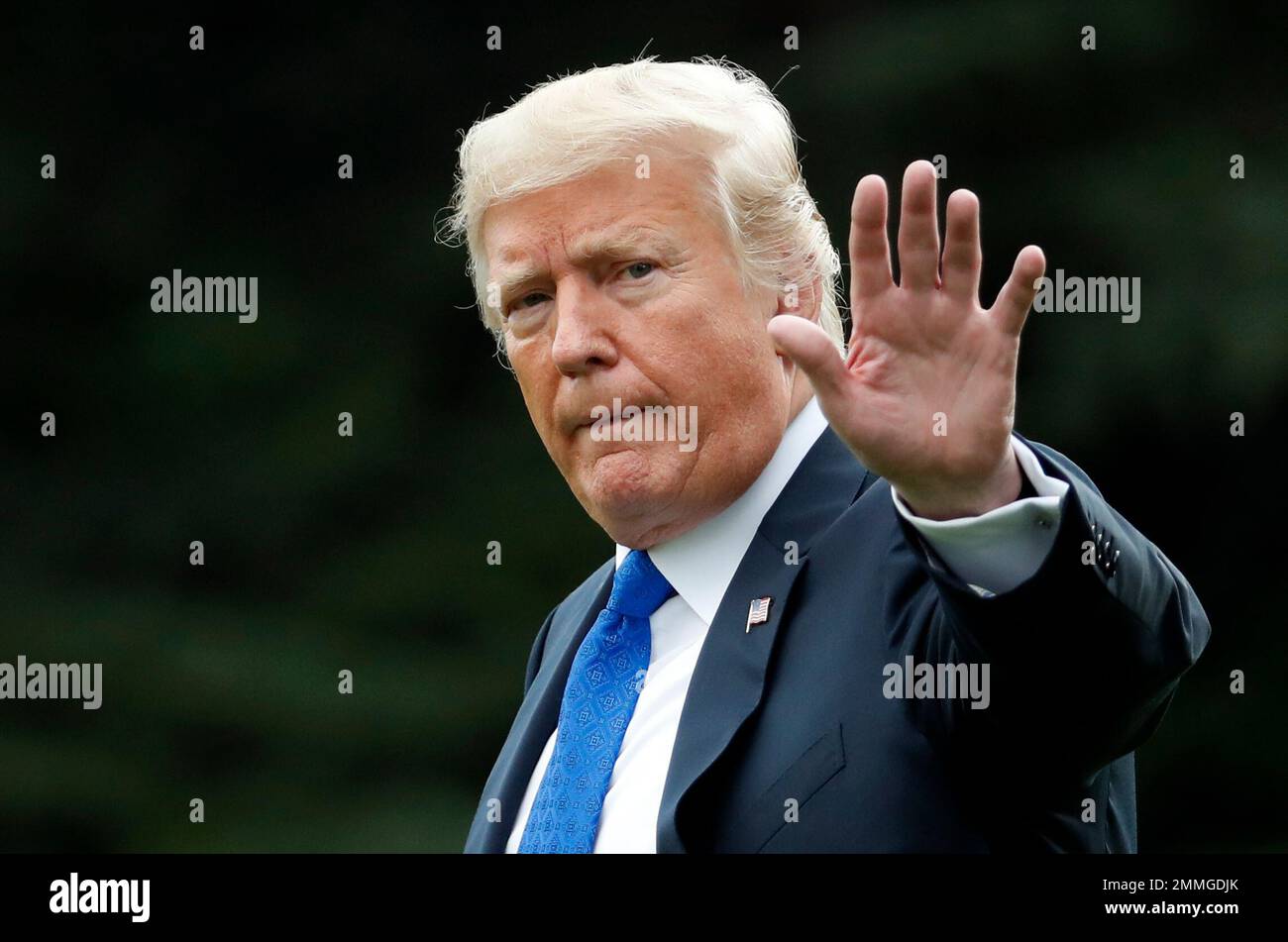 President Donald Trump waves as he walks to Marine One on the South ...