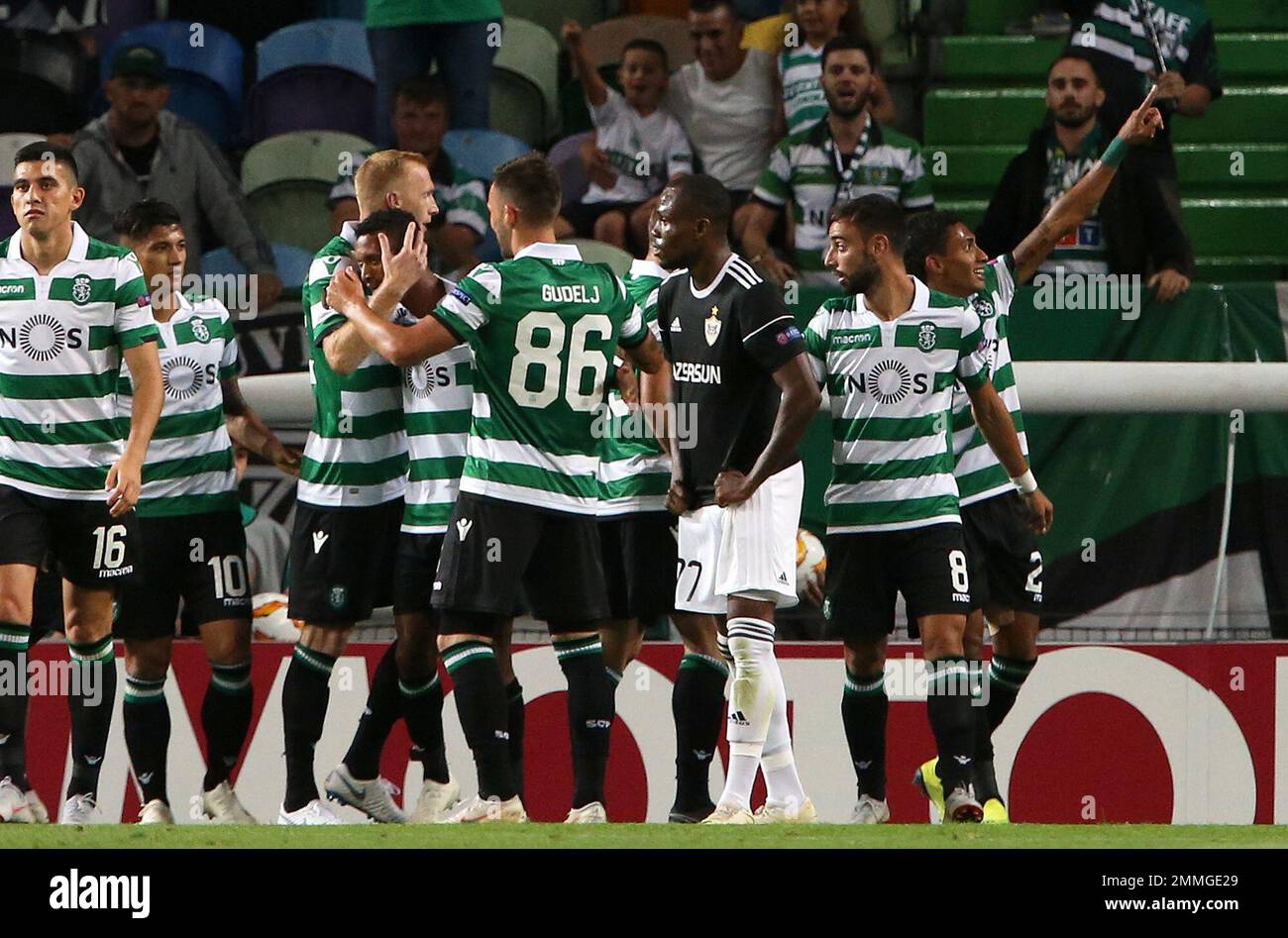 Sporting's Raphinha, right, celebrates after scoring the opening goal ...
