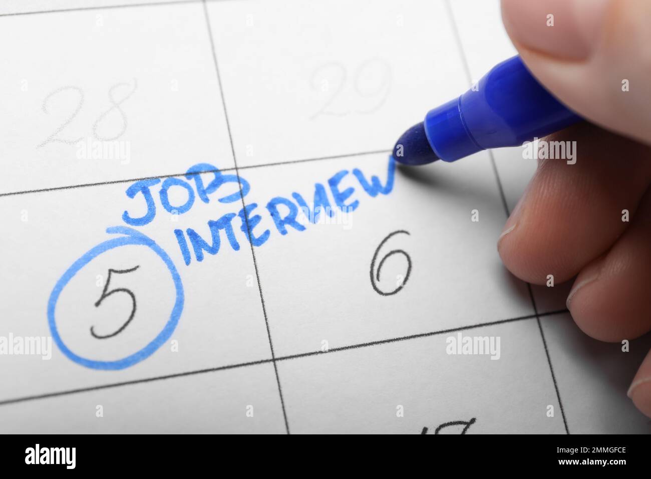 Woman marking date of job interview in calendar, closeup Stock Photo ...