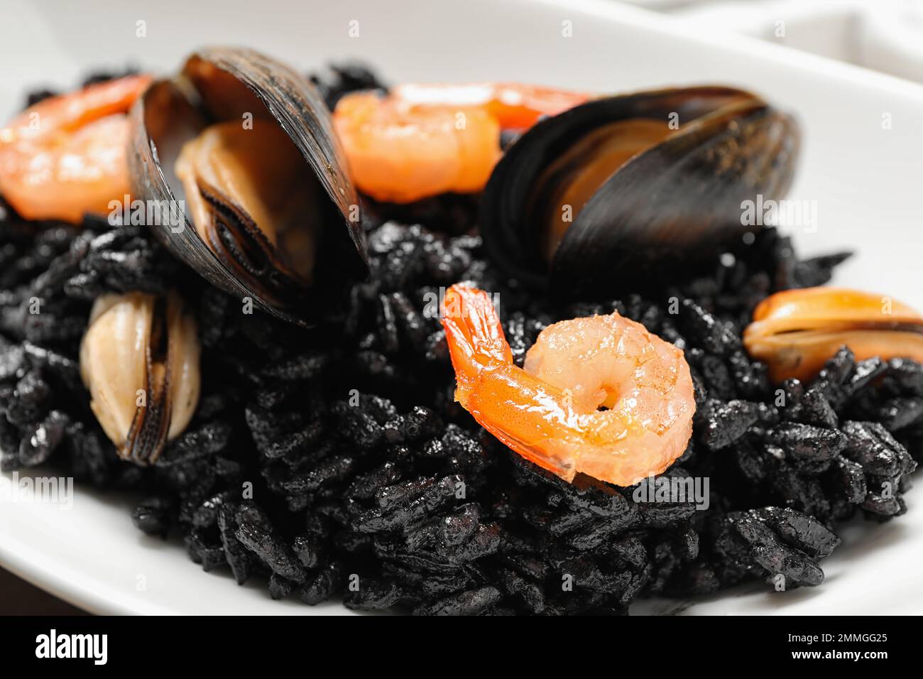 Delicious black risotto with seafood in plate, closeup Stock Photo - Alamy