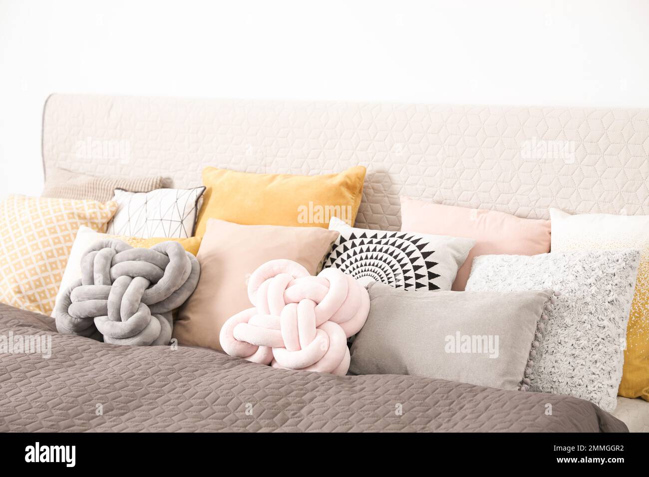 Large comfortable bed with many different pillows Stock Photo - Alamy