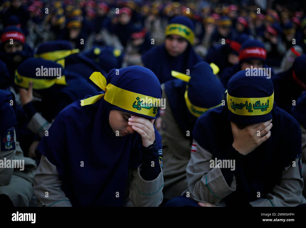 Shiite Muslim girls wearing bandanas that read, "At your service ...