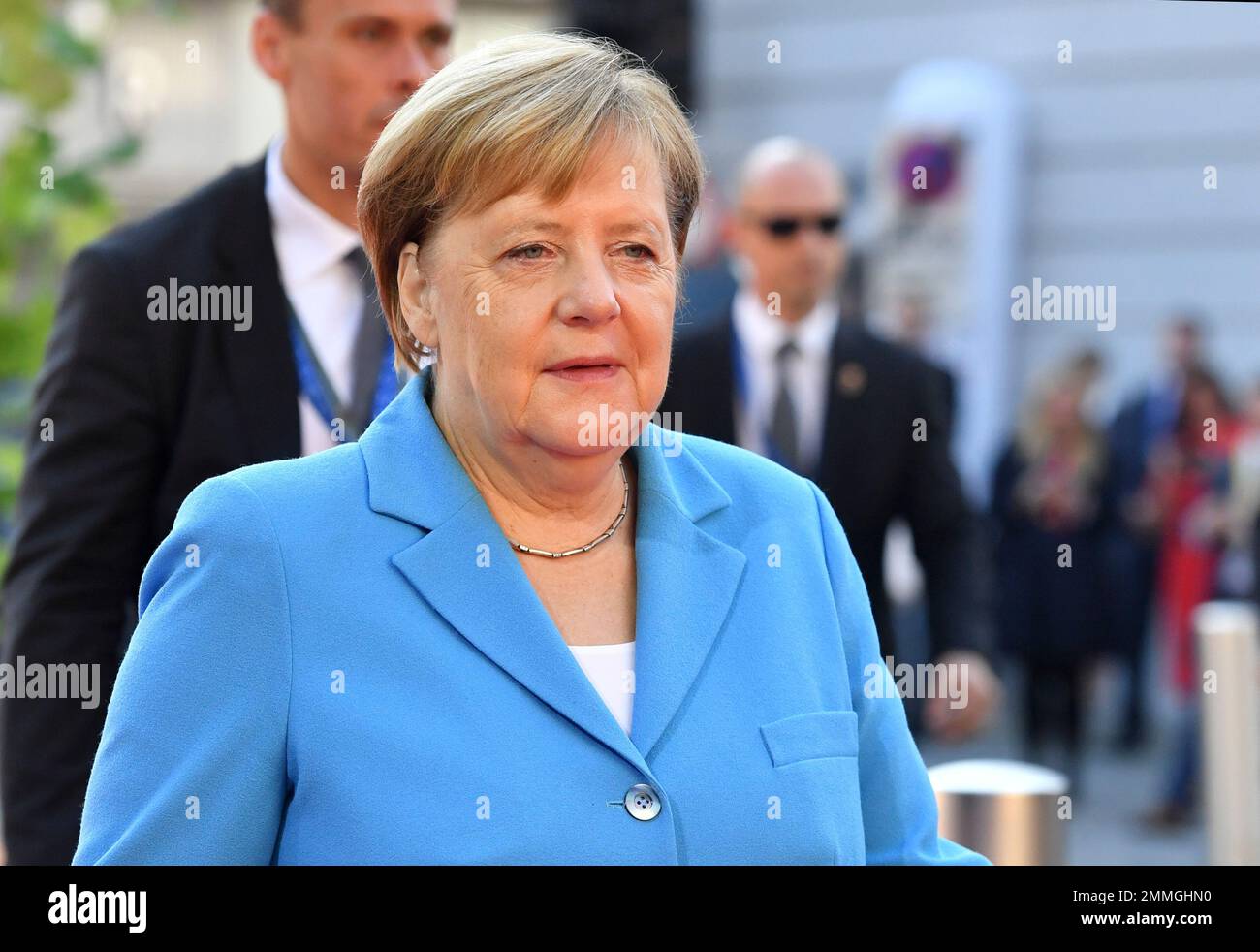 German Chancellor Angela Merkel passes by microphones when arriving at ...