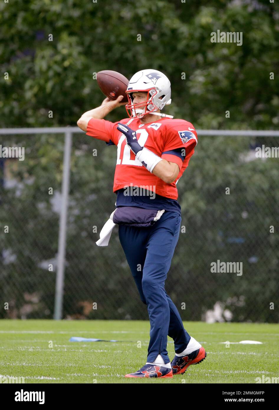 New England Patriots quarterback Tom Brady winds up to throw the ball ...