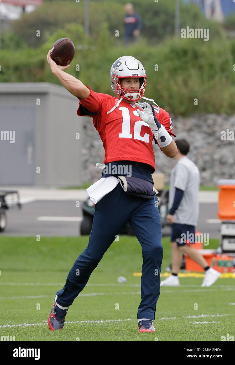 New England Patriots quarterback Tom Brady winds up to throw the ball ...