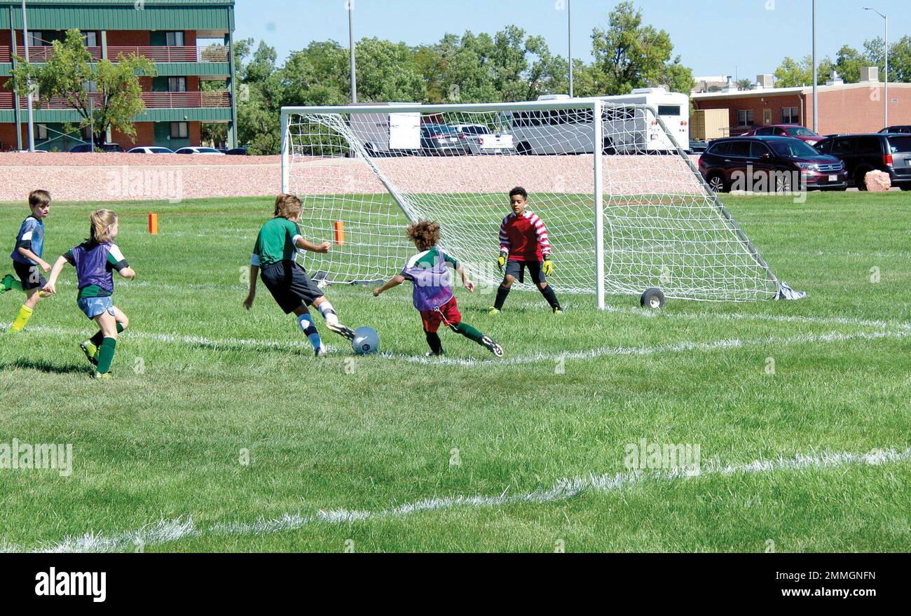 FORT CARSON, Colo. — Youth soccer players compete for the ball during ...