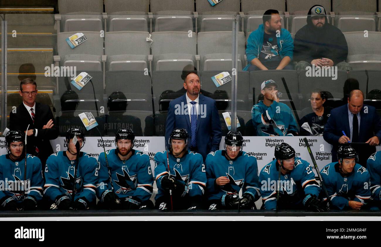 San Jose Sharks coach Peter DeBoer stands behind players on the bench ...