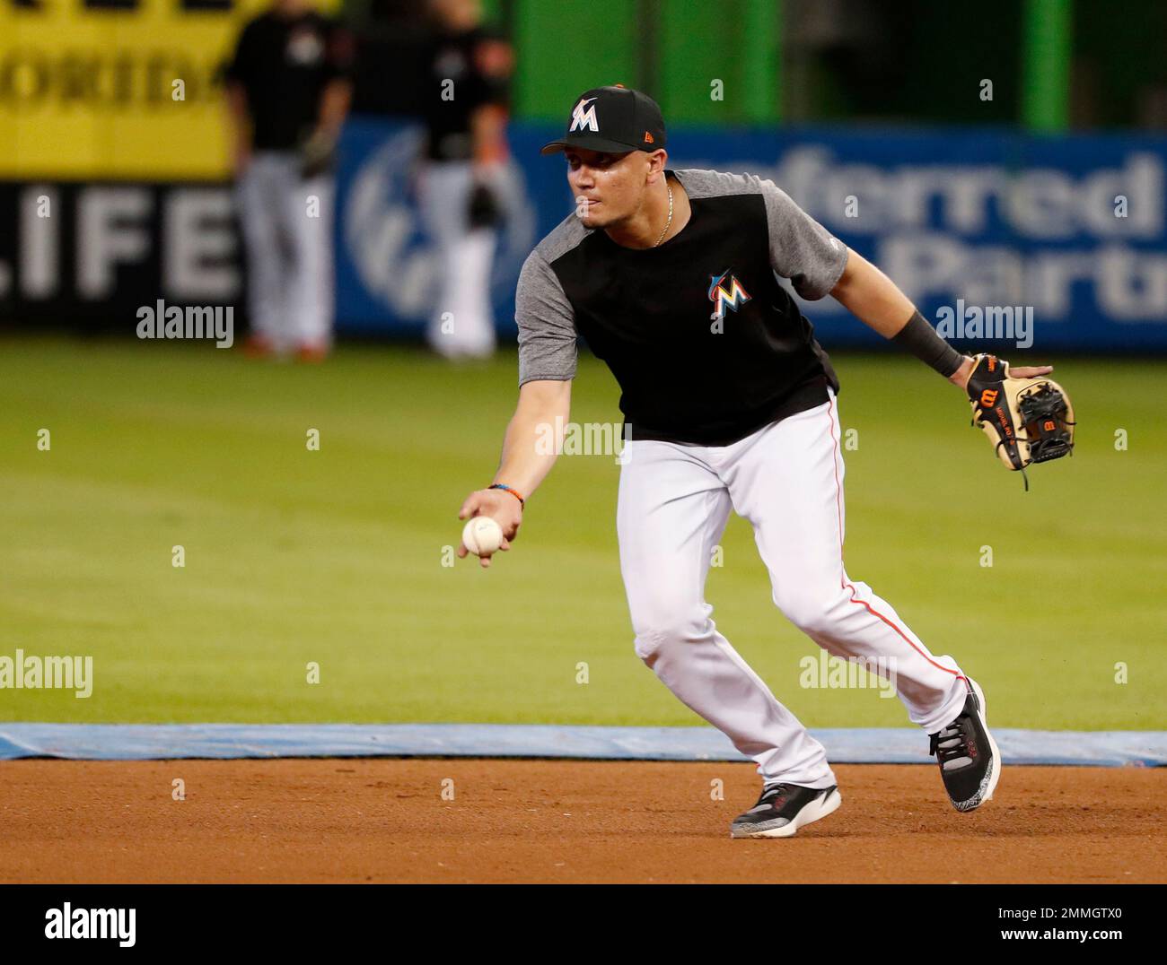 Miami Marlins second baseman Miguel Rojas fields a ball during batting ...