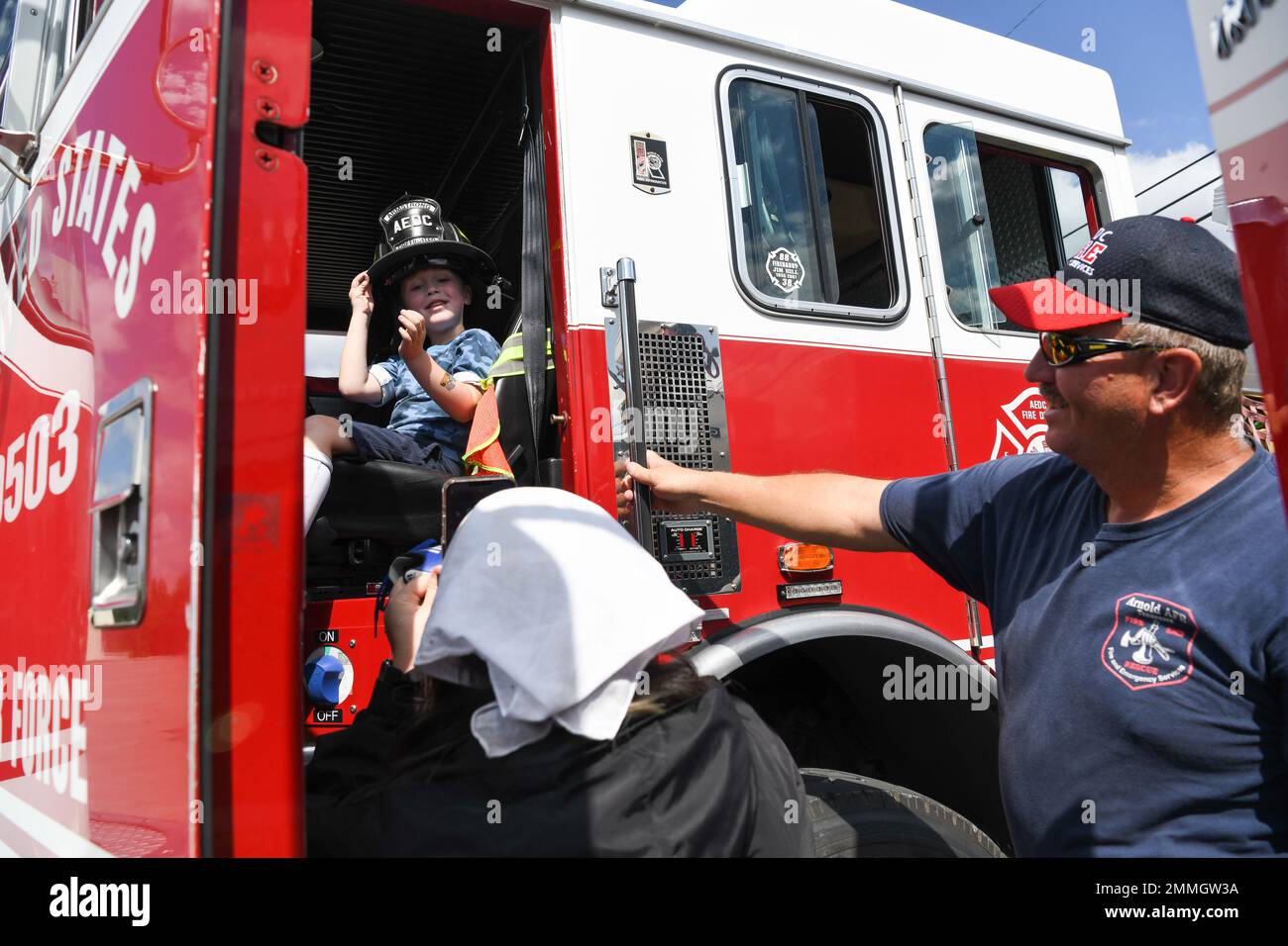 Joshua McDonald, 5, tries on a firefighter's helmet as his mother takes ...