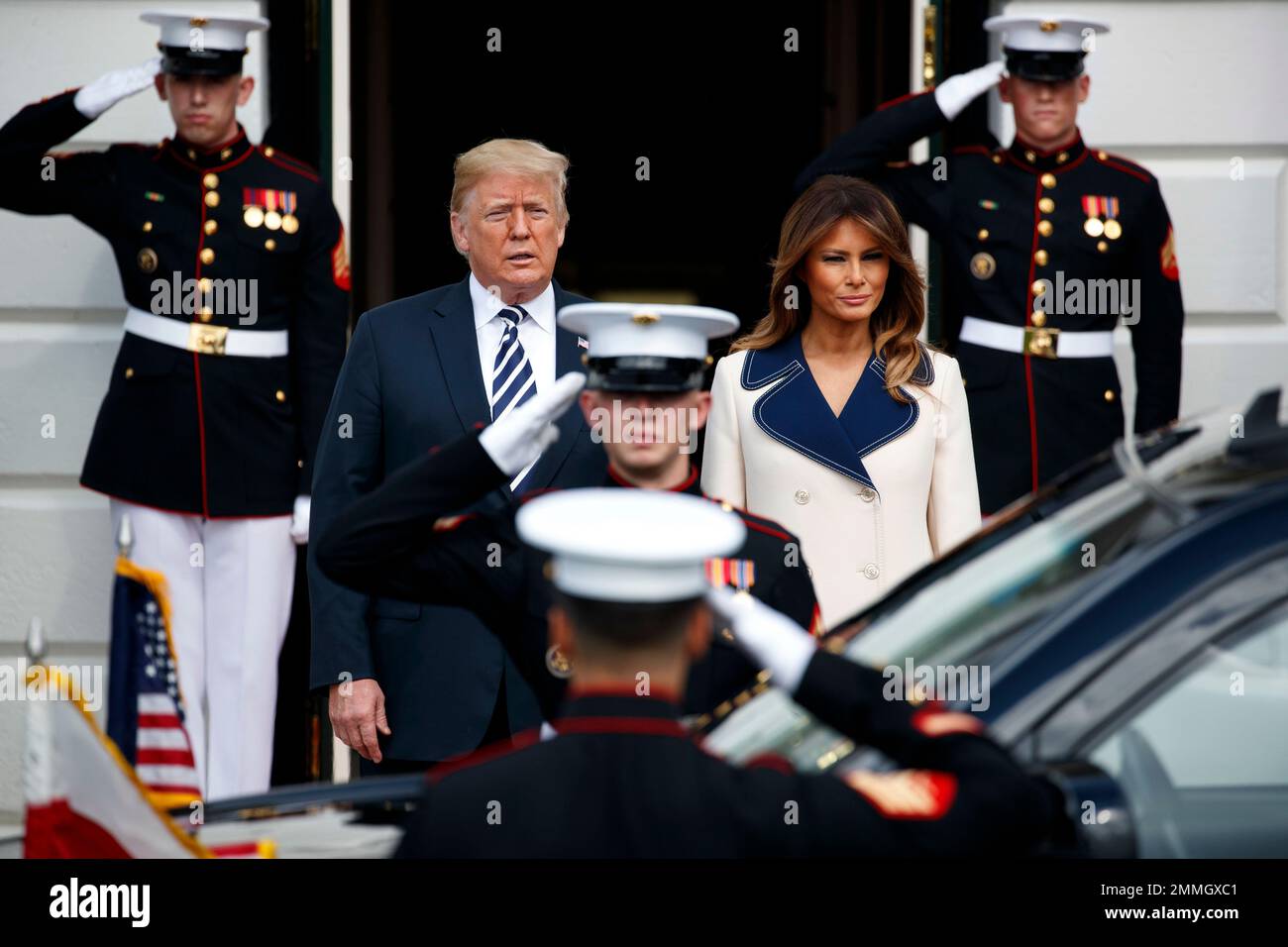 President Donald Trump and first lady Melania Trump walk out of the ...