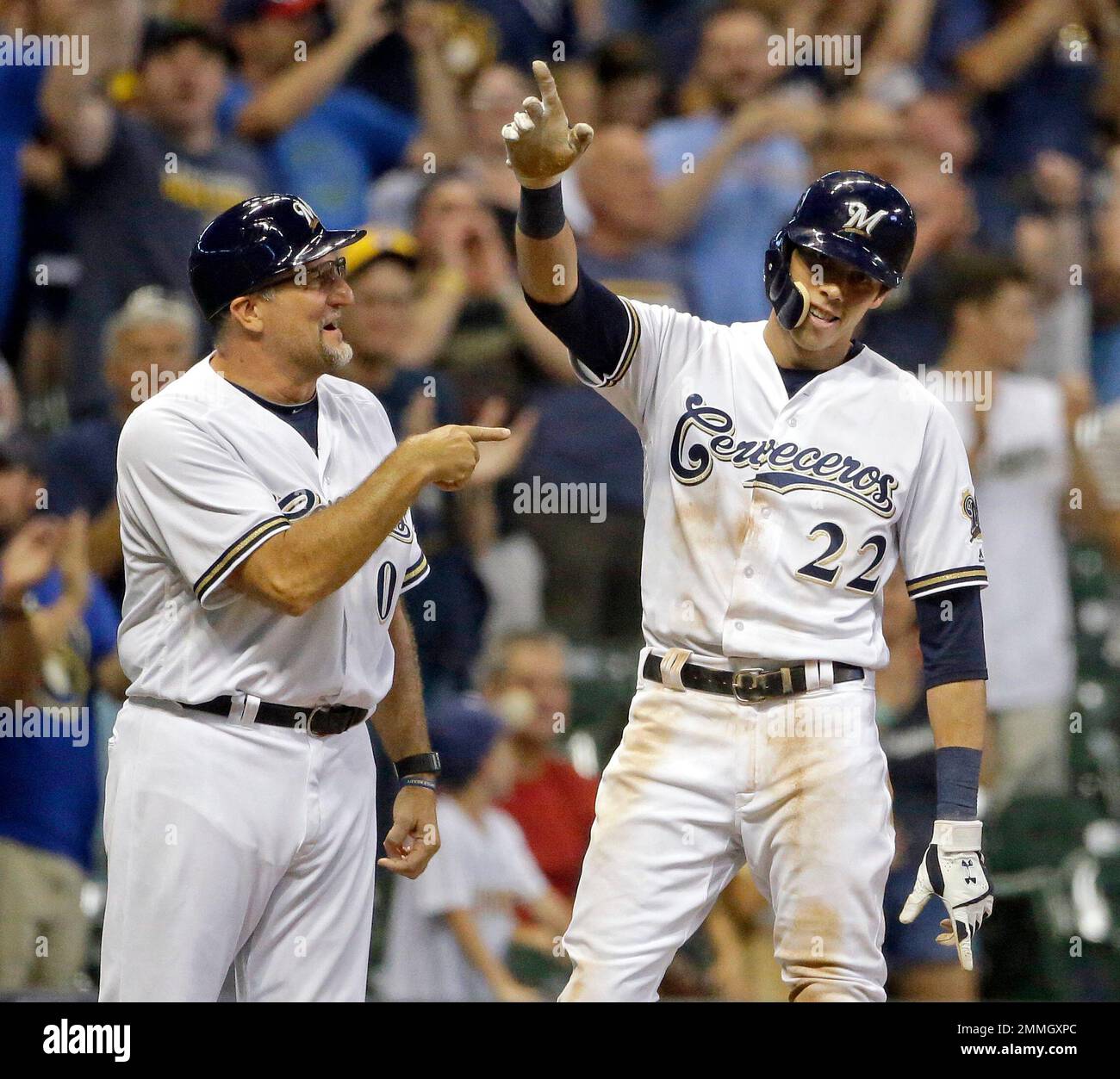Milwaukee Brewers' Christian Yelich (22) celebrates with Ed Sedar after ...