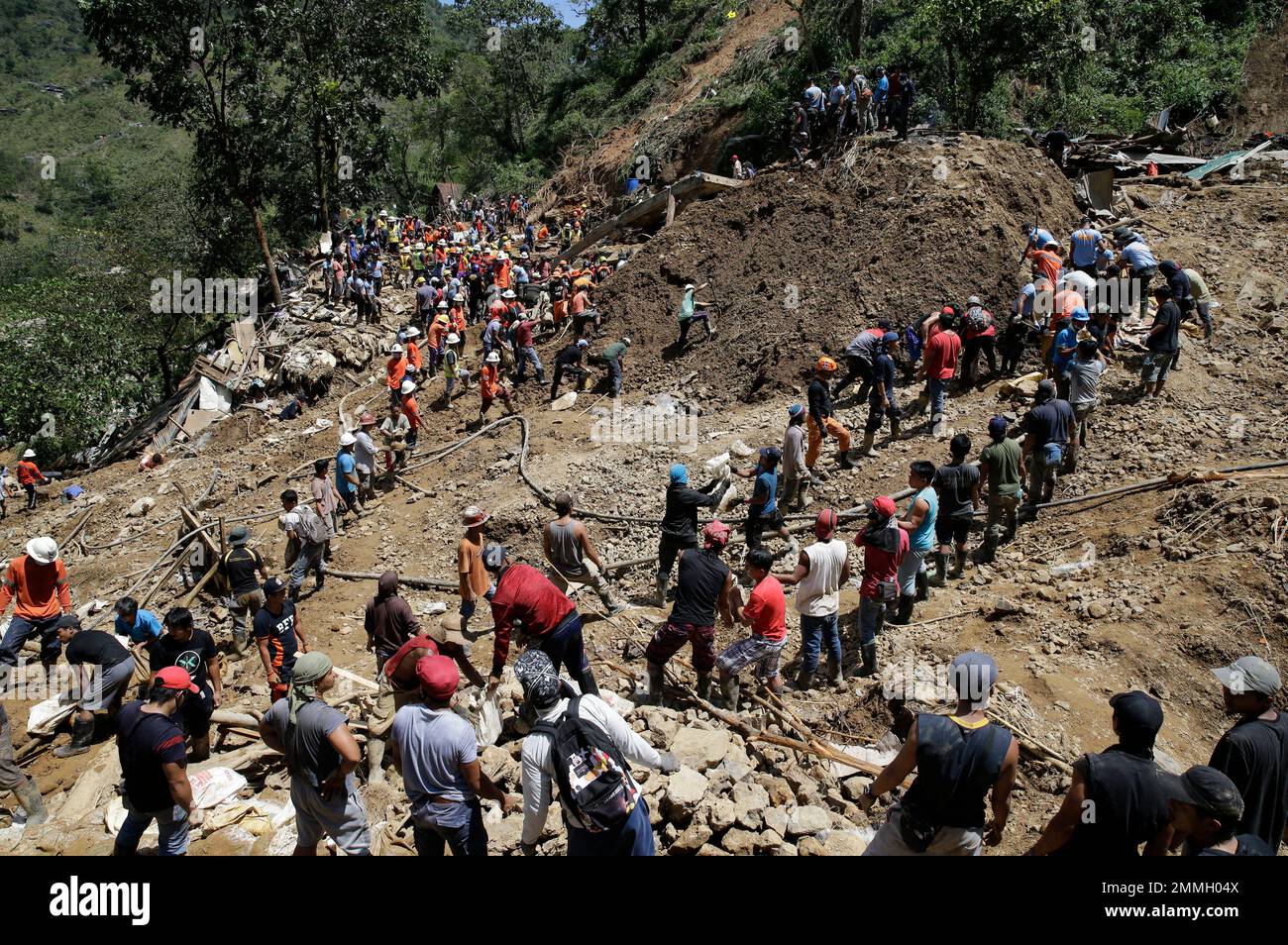 Rescuers continue search operations at the site where victims are believed to be buried in a ...