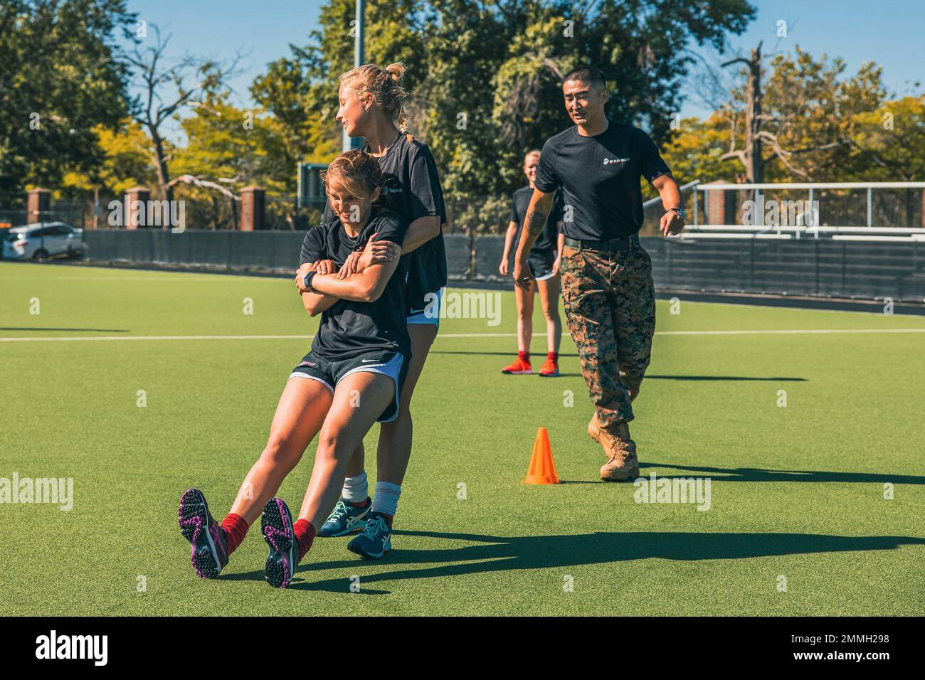 A member of Harvard University’s field hockey team conducts the buddy ...