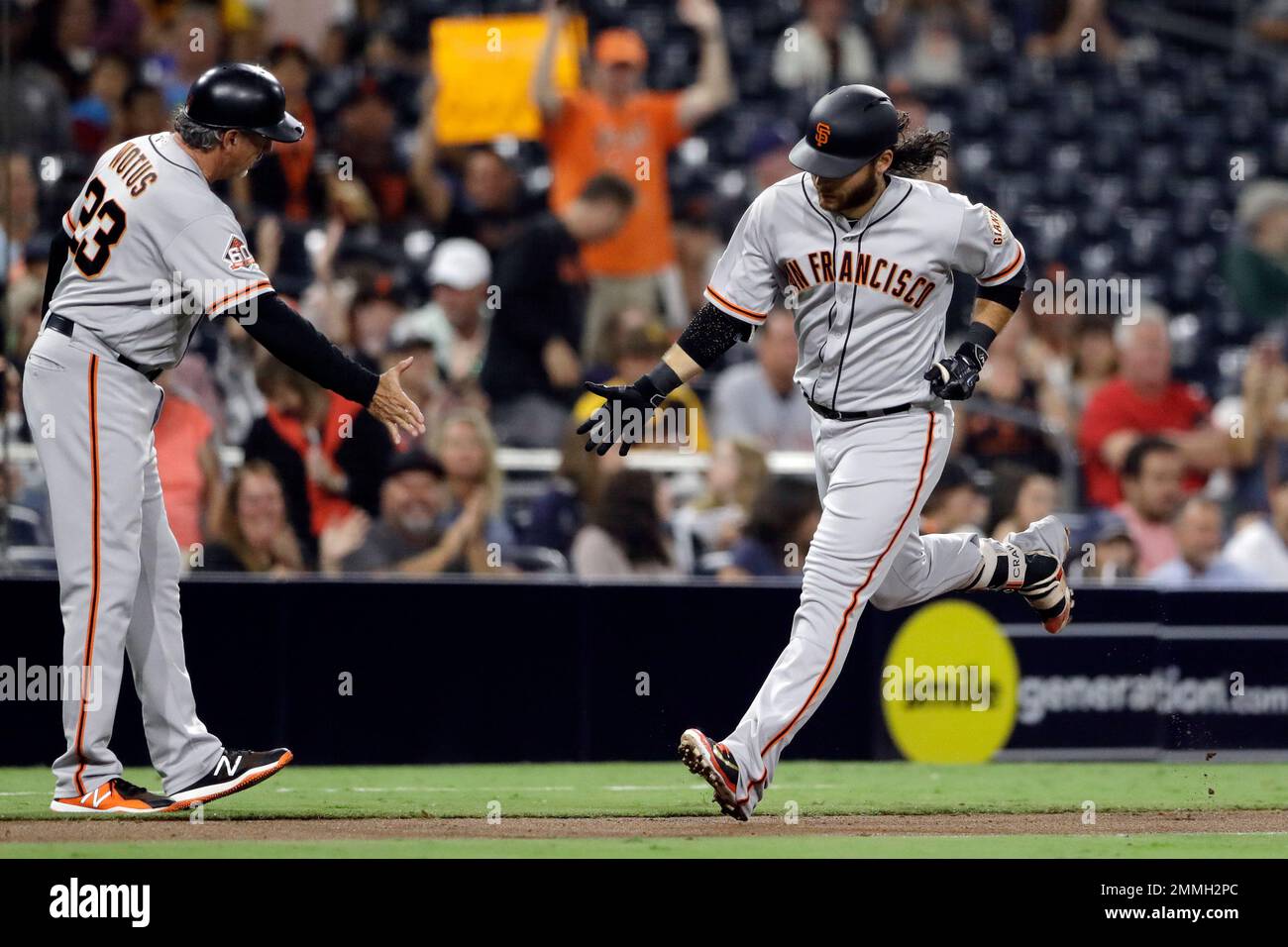 San Francisco Giants' Brandon Crawford, right, is greeted by third base ...