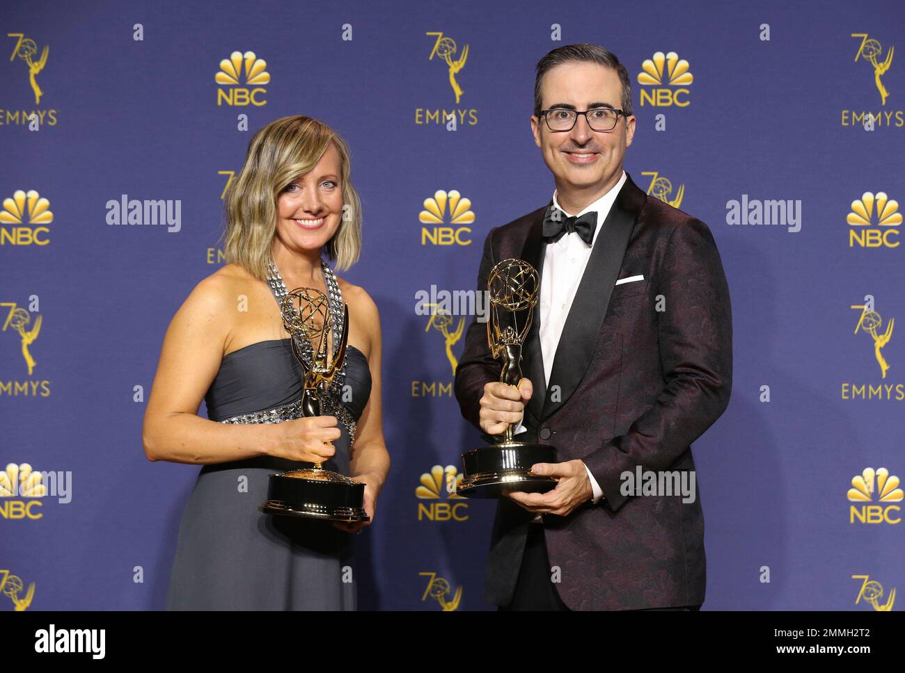 Liz Stanton, left, and John Oliver pose in the press room with the ...