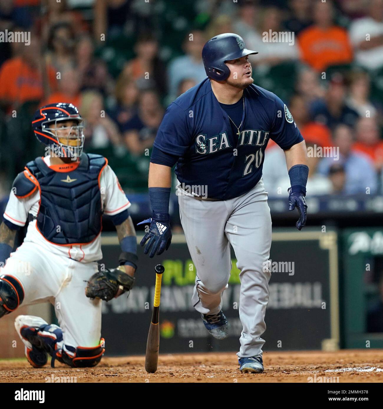 Seattle Mariners' Daniel Vogelbach (20) drops his bat after hitting a ...