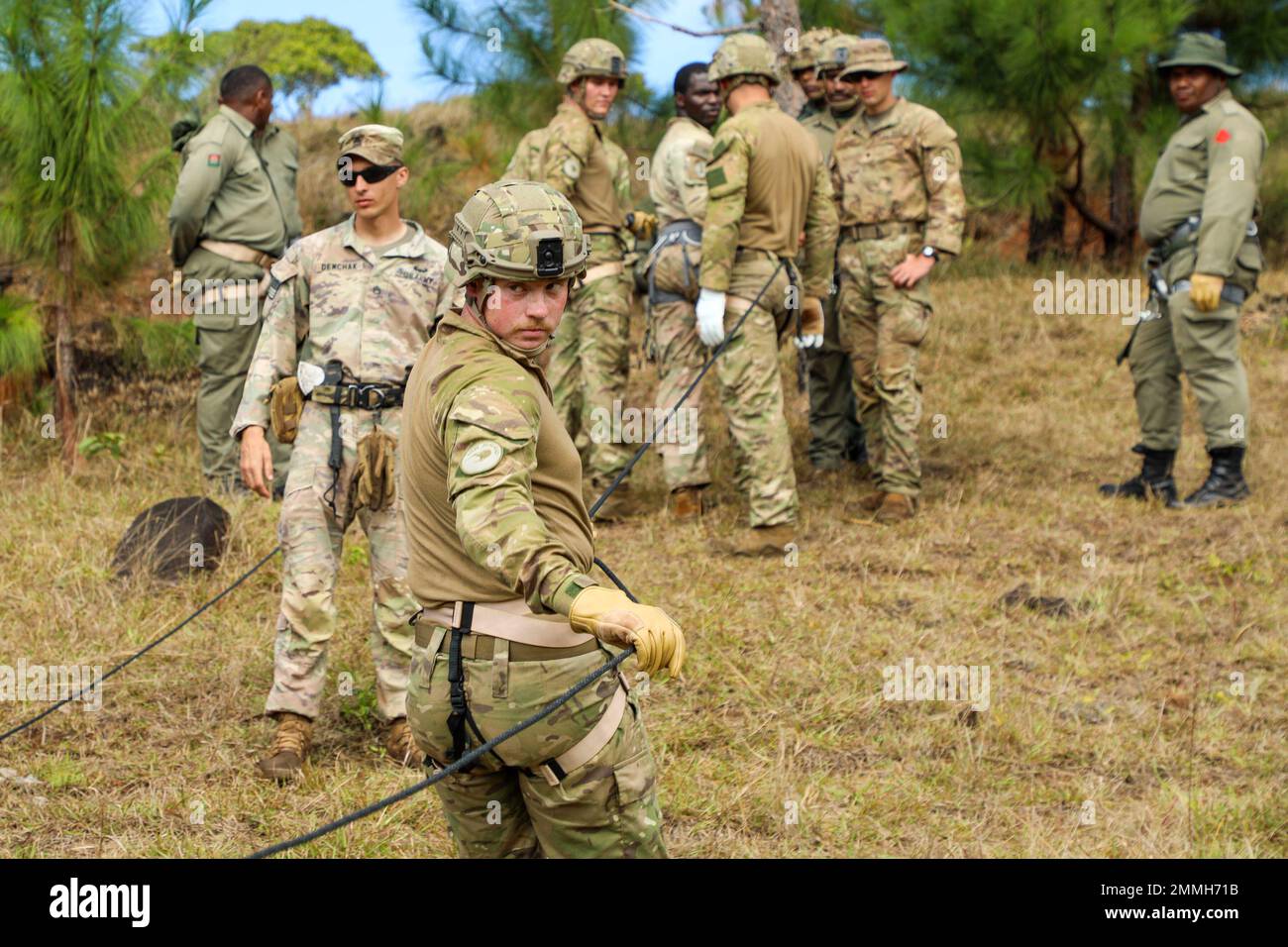 A New Zealand soldier looks down his training descent rope during ...
