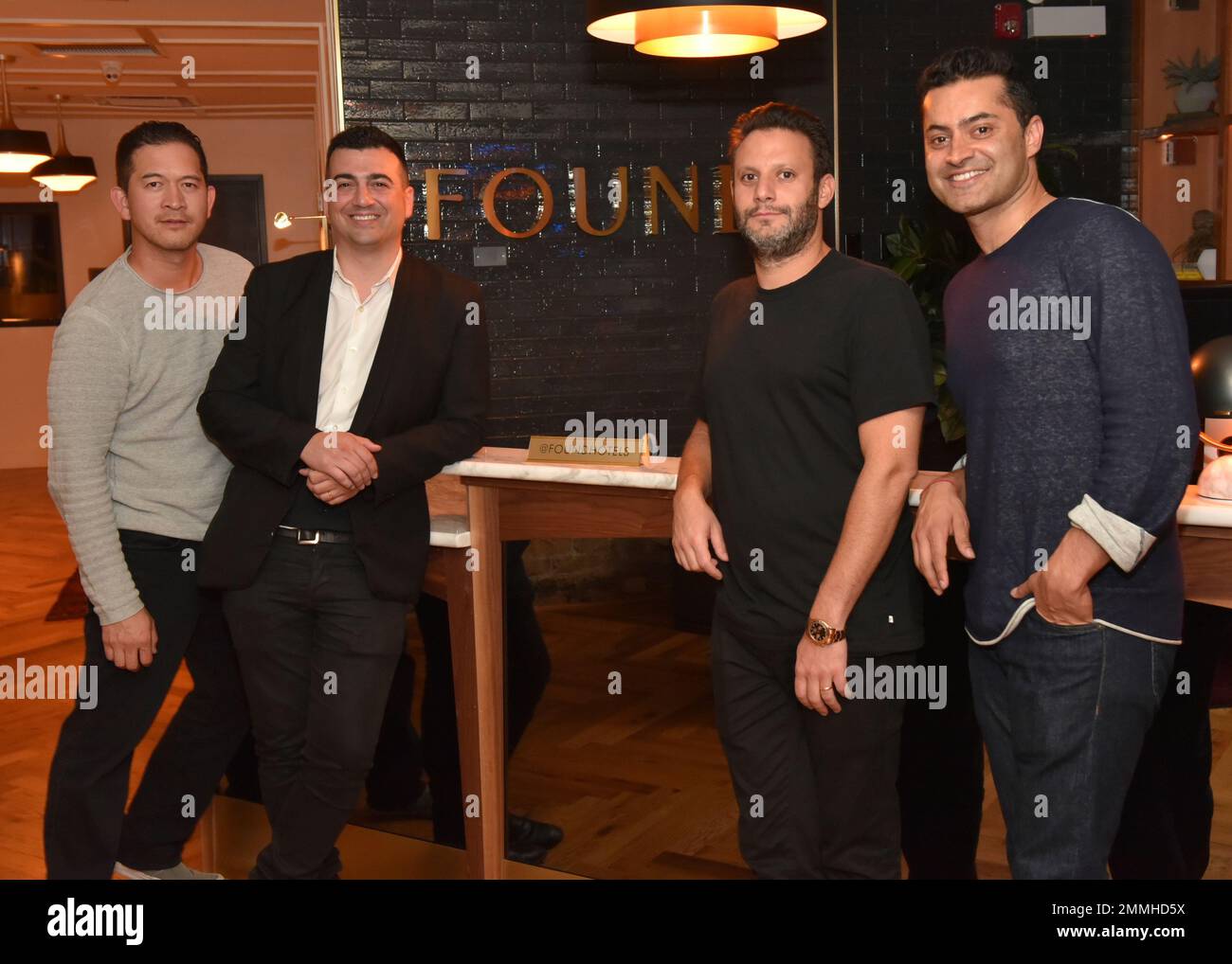 Ross Walker, (from left) John Terzian, Brian Toll, and Karan Suri attend the grand opening of ...