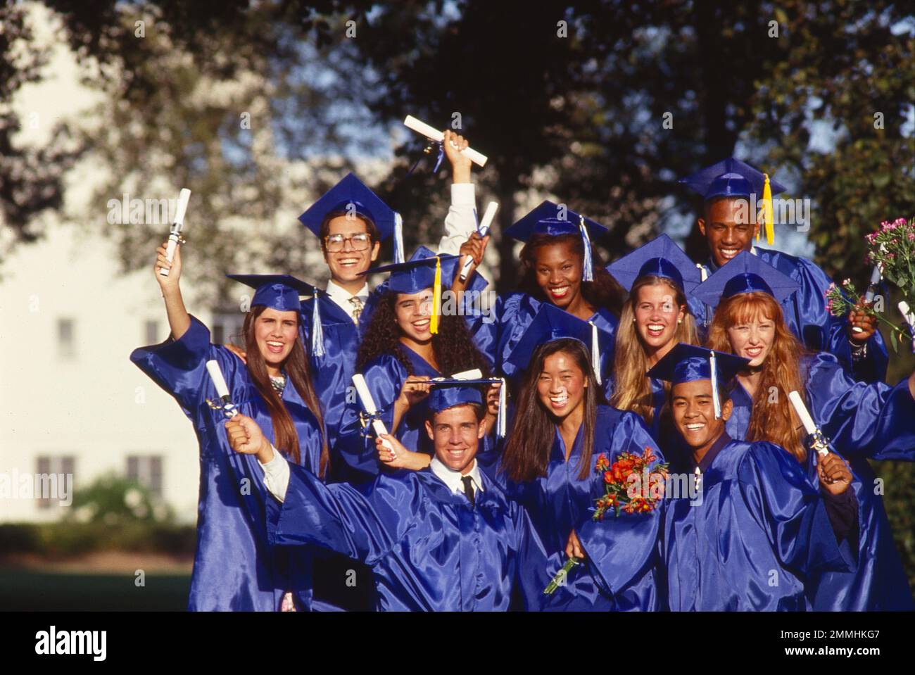 Group shot of a bunch of happy college graduates in their caps and ...