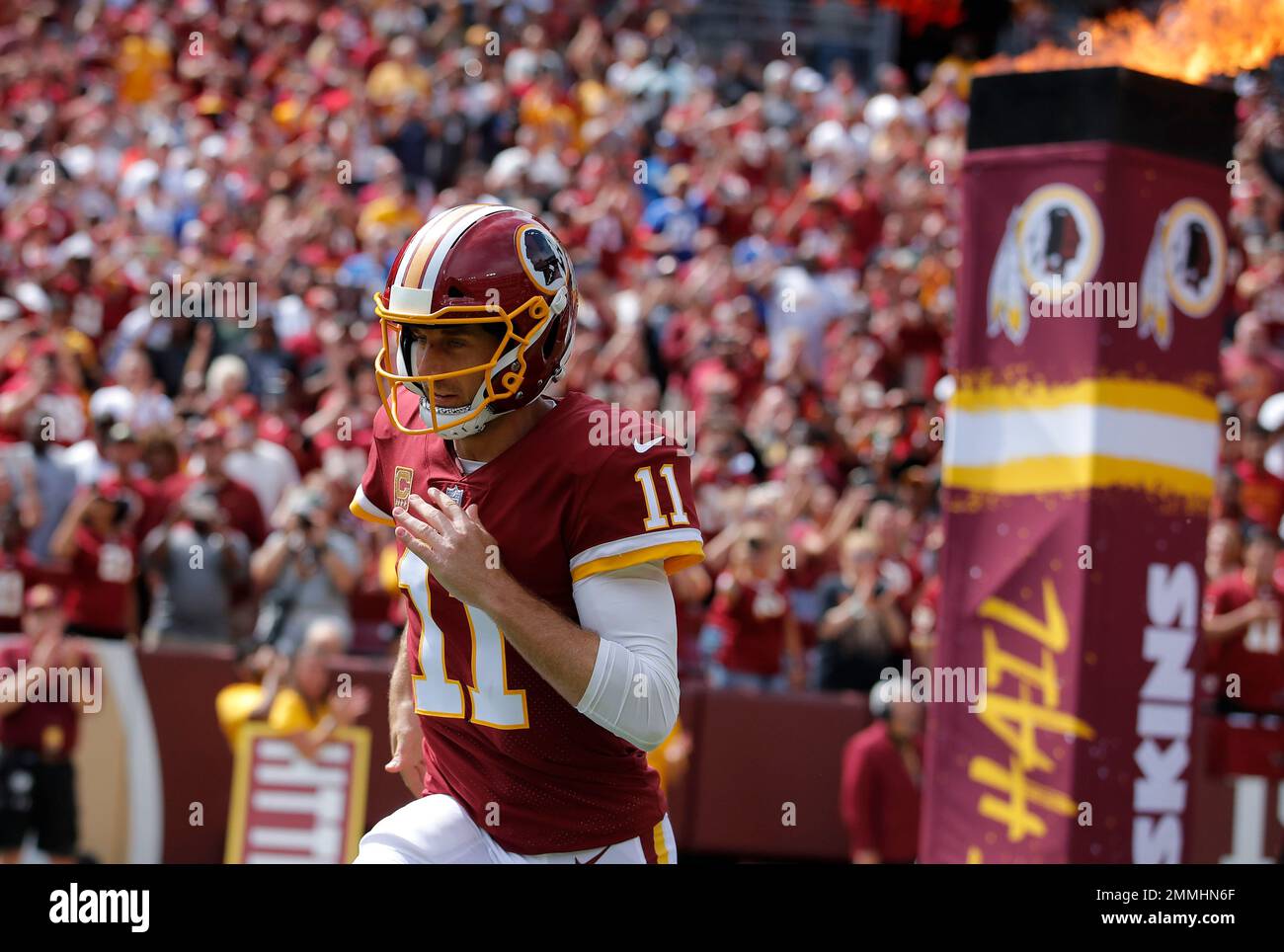Washington Redskins quarterback Alex Smith runs onto the field before ...