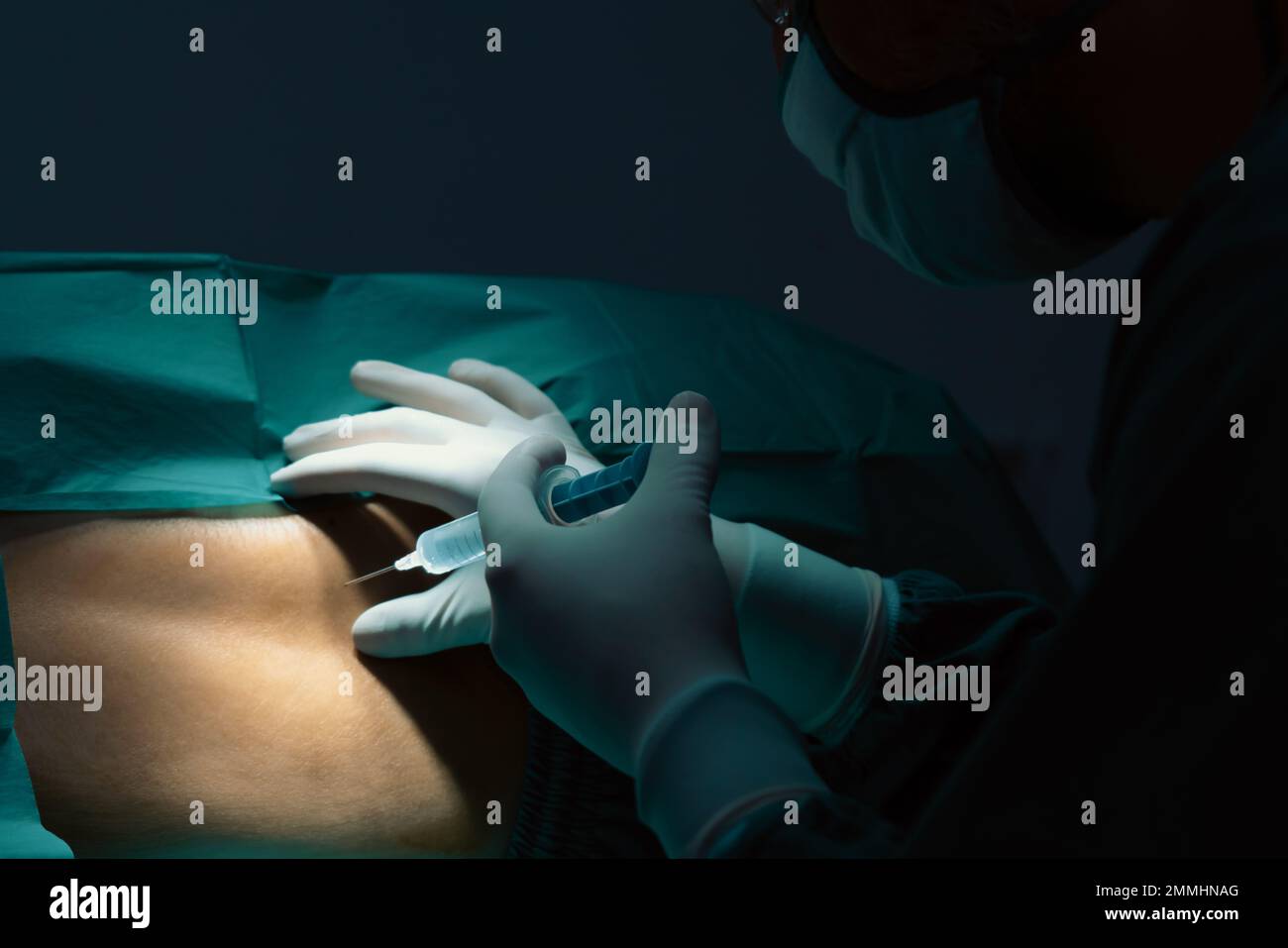 Surgeon inject anesthesia with syringe into the patient before perform ...