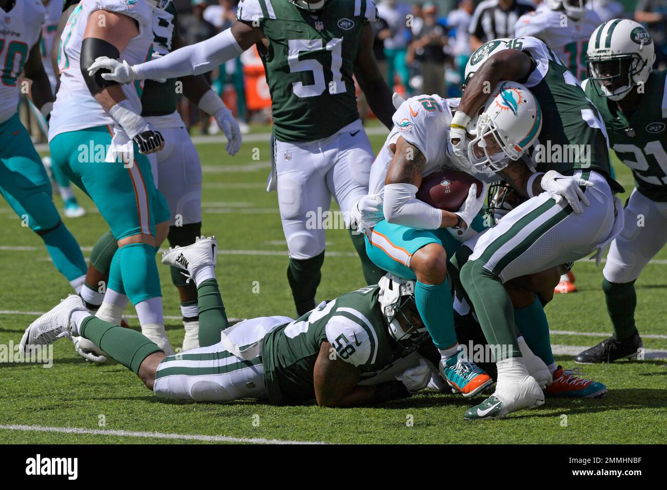 New York Jets' Doug Middleton (36) and Darron Lee (58) tackle Miami ...